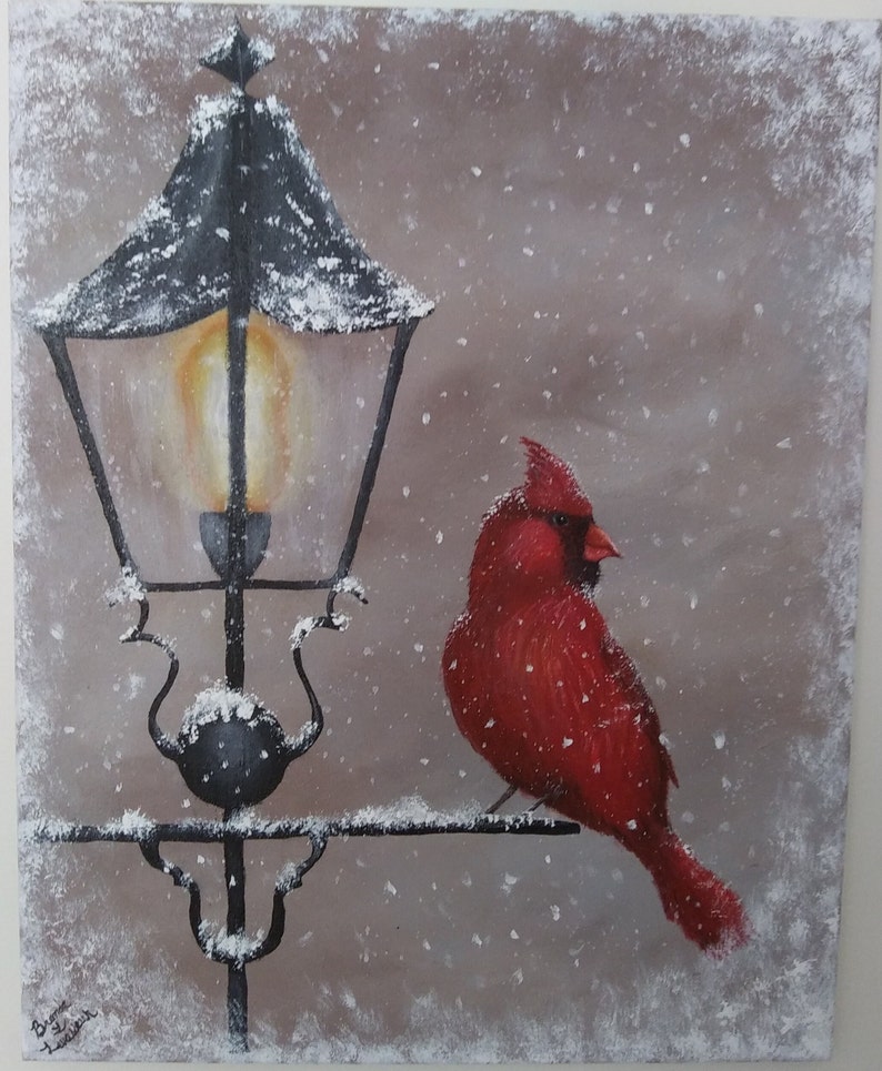 Beautiful Red Cardinal Bird on a Glowing Light Post on a Snowy Day ...