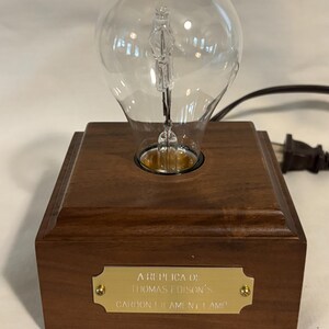 Replica of Thomas Edison Carbon Filament Bulb on Wooden Base Lights Up ...
