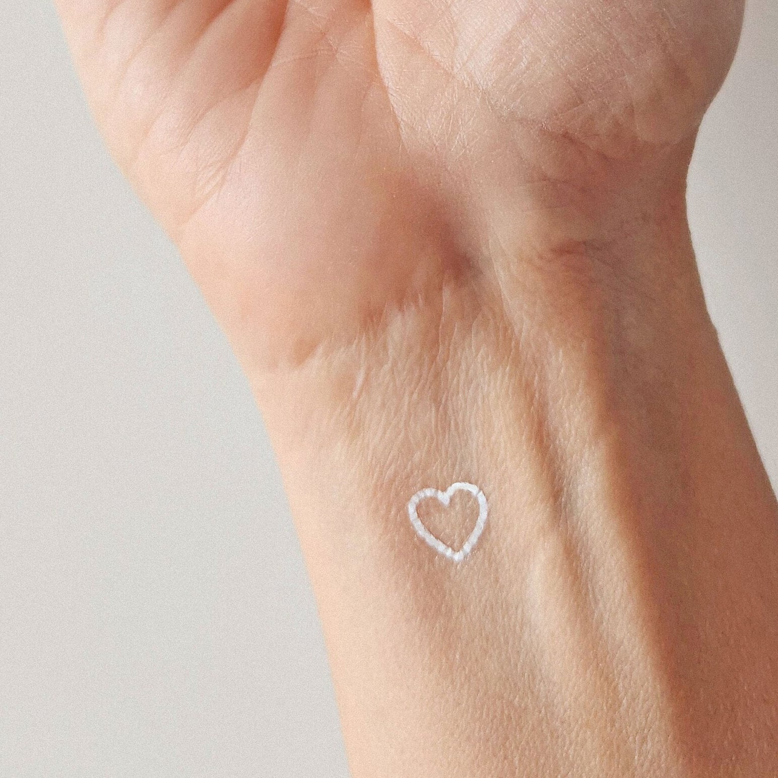 White Heart Wrist Tattoos