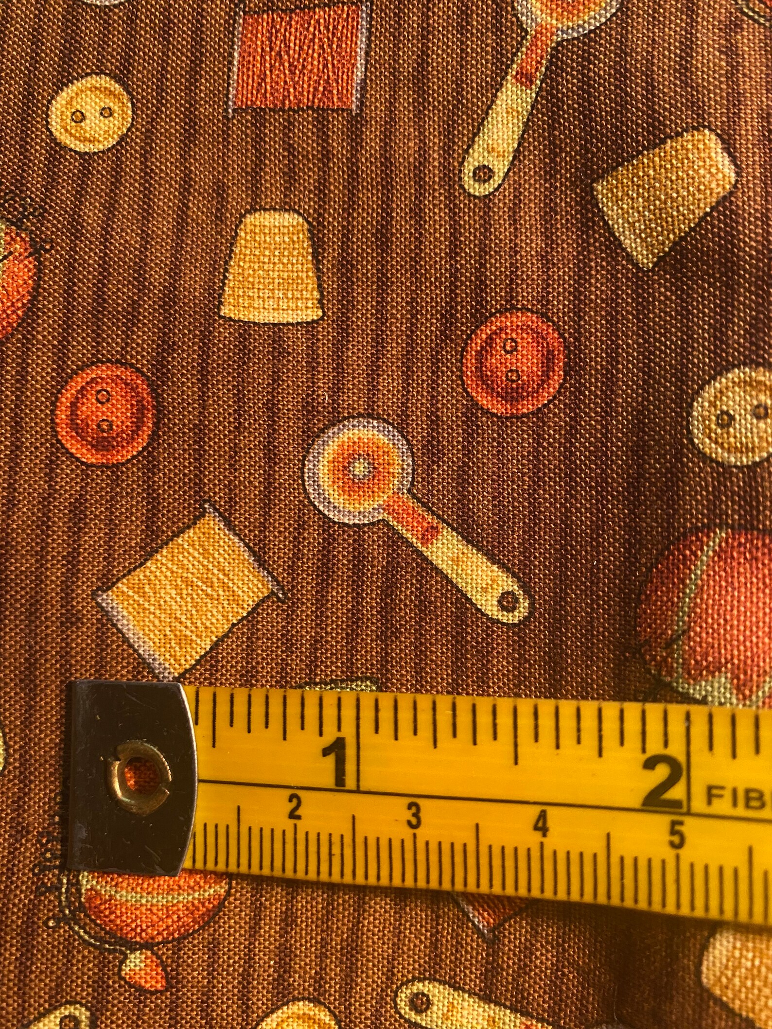 Brown Background With Sewing Notions Thimbles Buttons Pincushion Etc ...