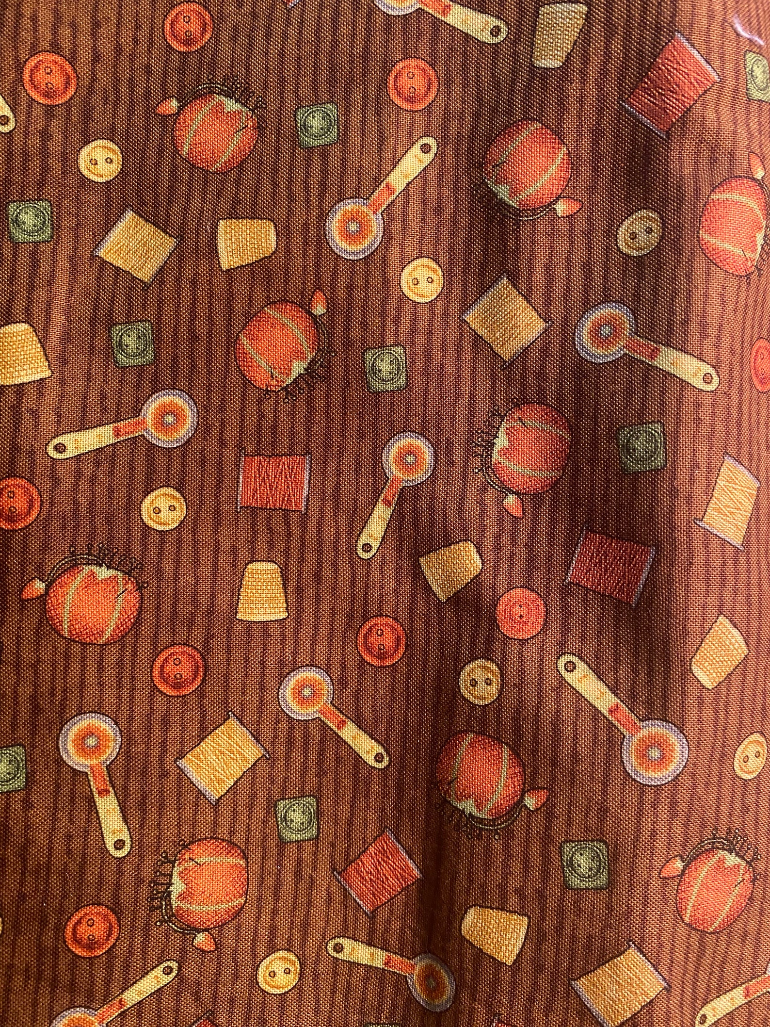 Brown Background With Sewing Notions Thimbles Buttons Pincushion Etc ...
