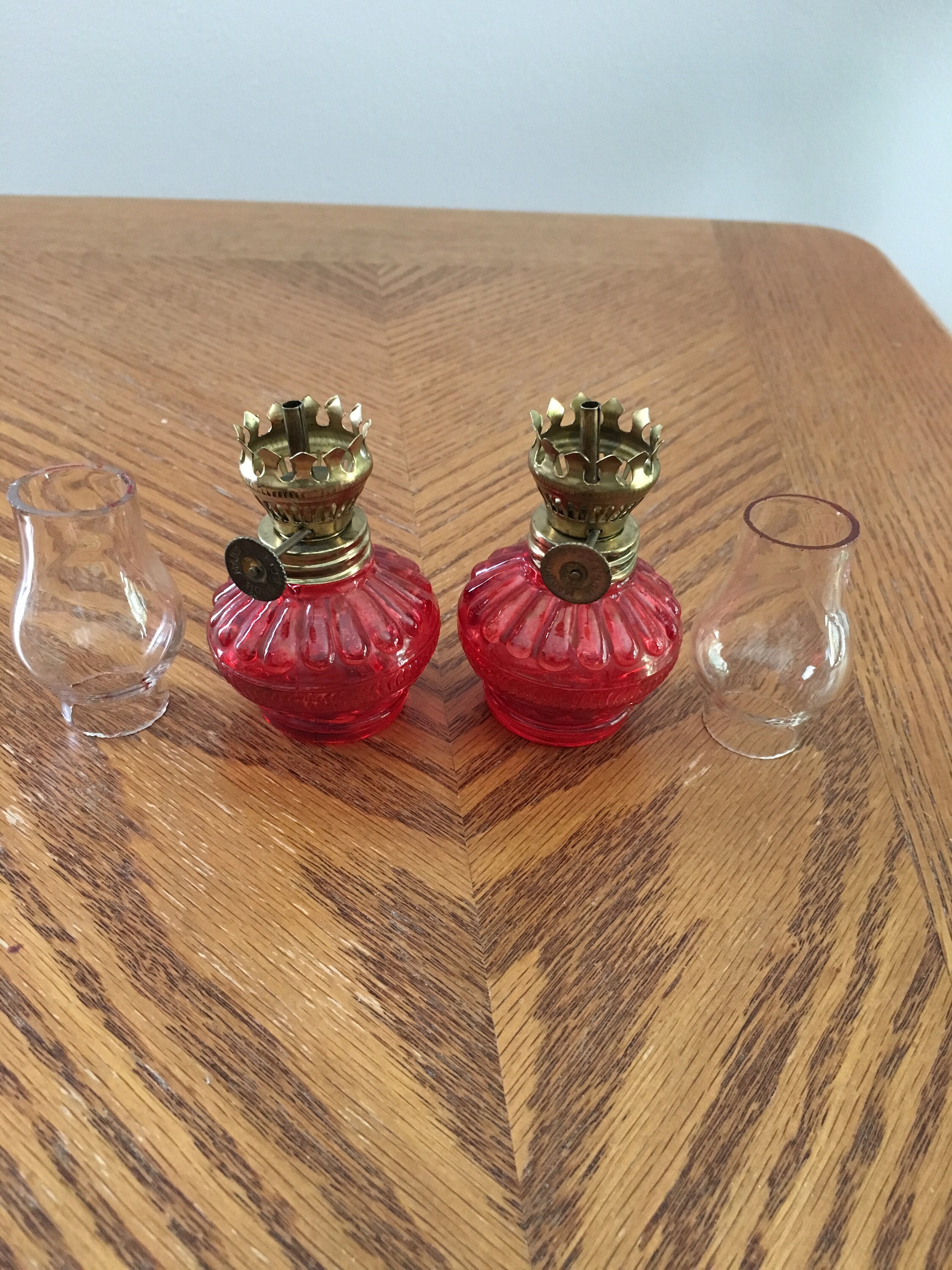 Vintage pair of red minature oil lamps with chimneys