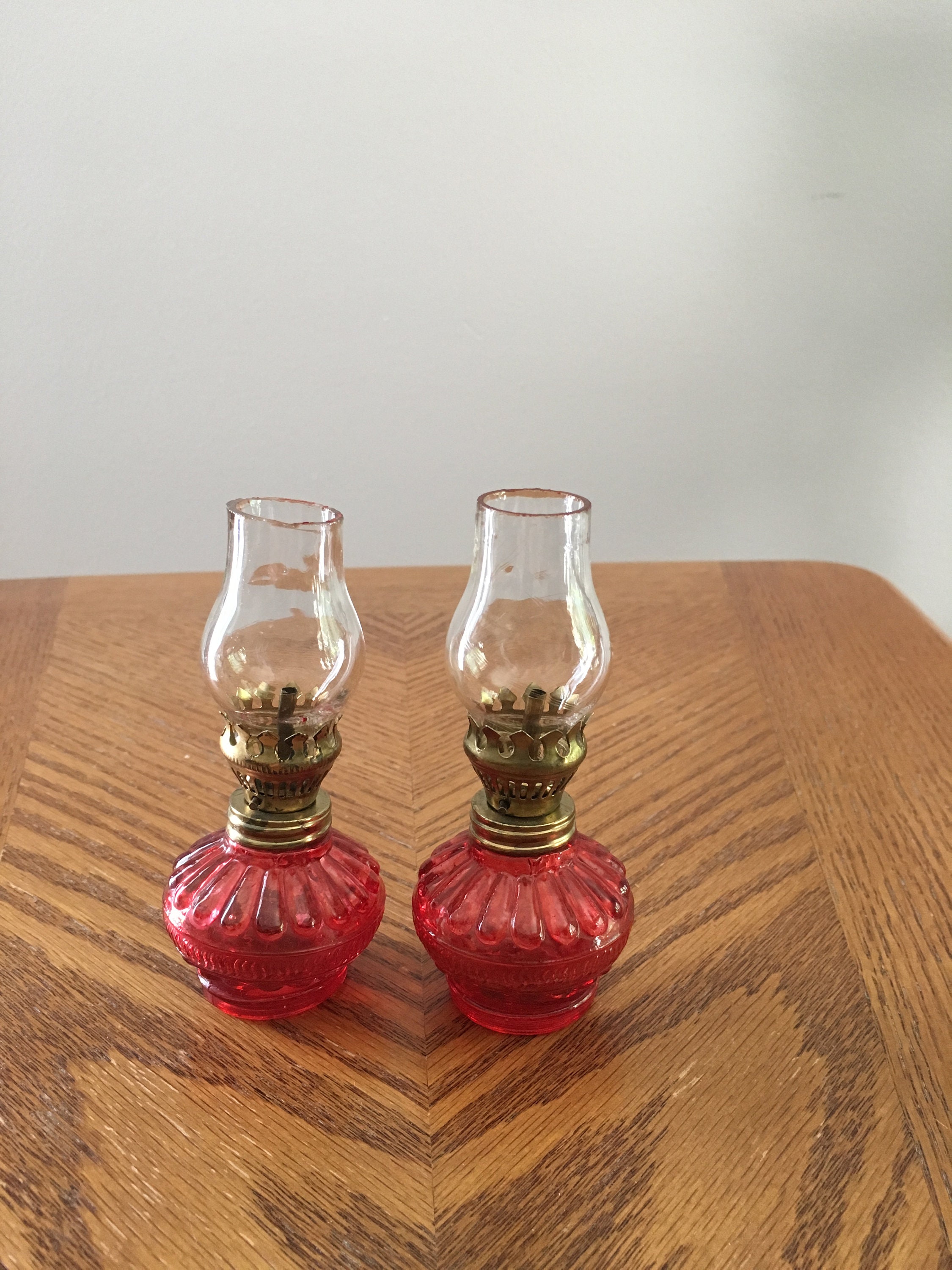 Vintage pair of red minature oil lamps with chimneys