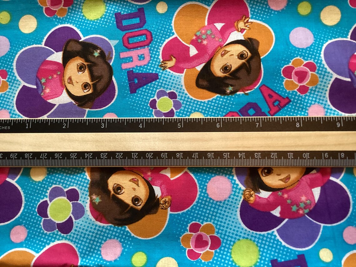 Totally Dora Floral Badges Blue Fabric Quilting Crafting Fabric Kids ...
