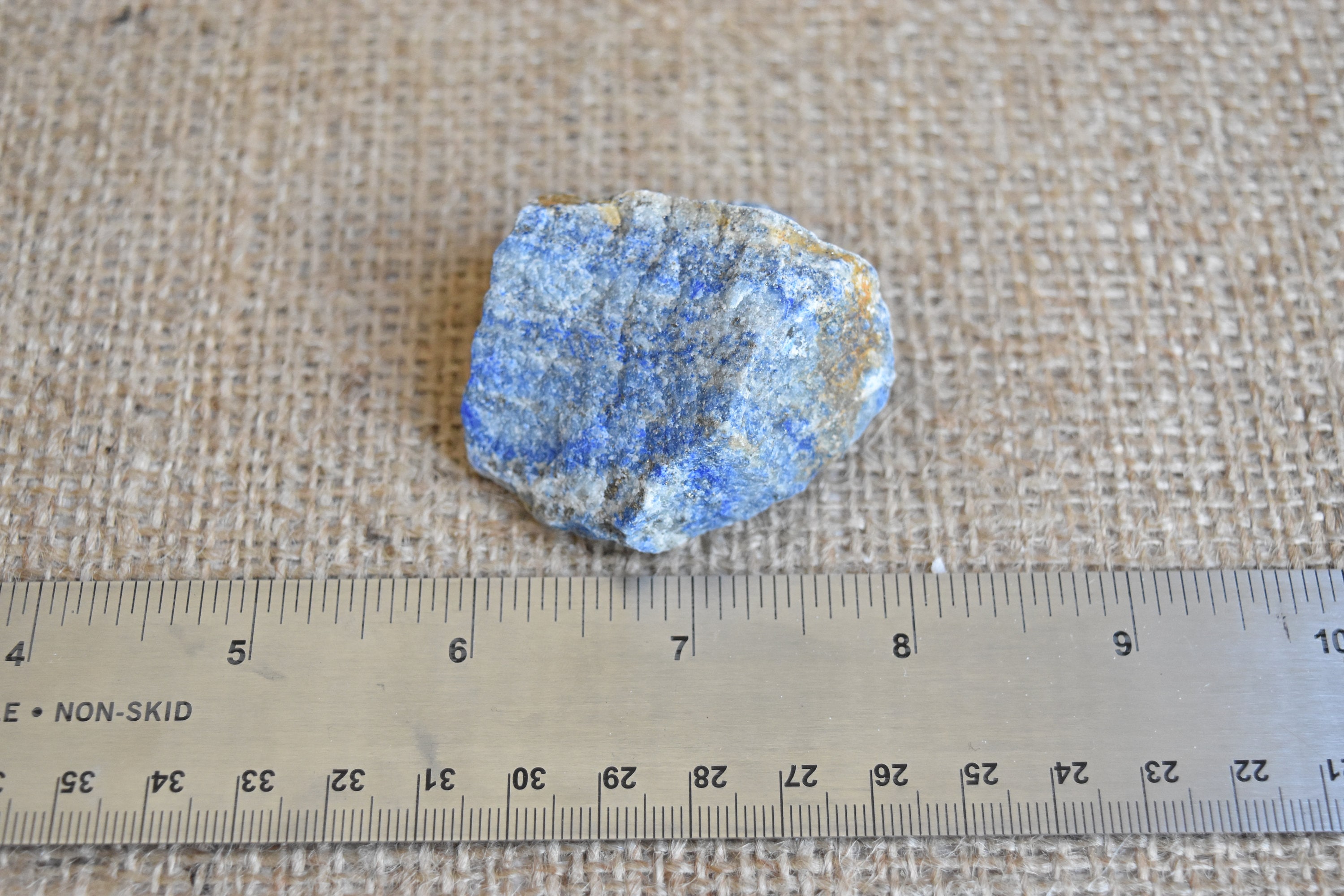 Fluorescent marialite (scapolite), calcite, pyrite, and lapis lazuli ...