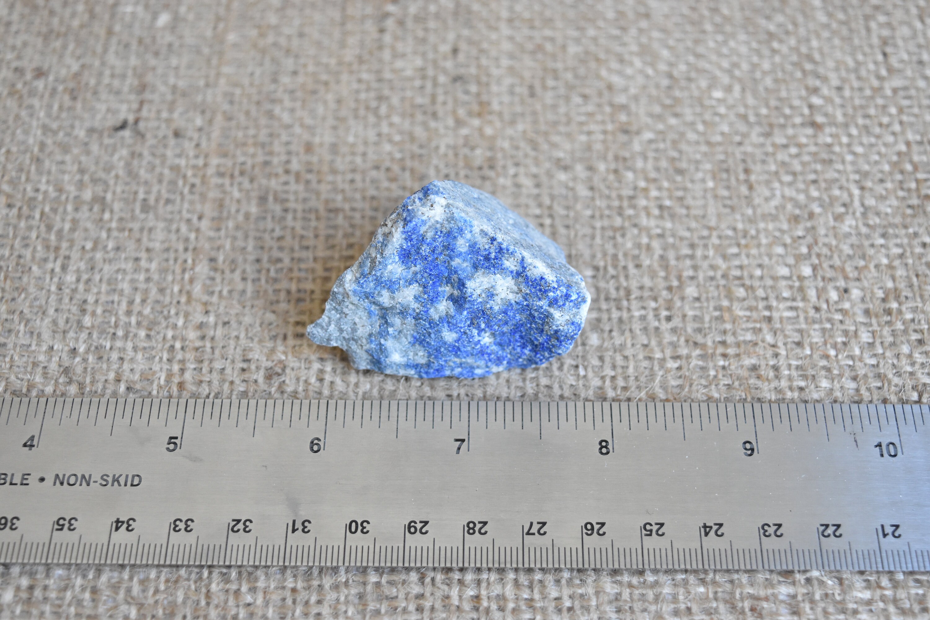 Fluorescent marialite (scapolite), calcite, pyrite, and lapis lazuli ...