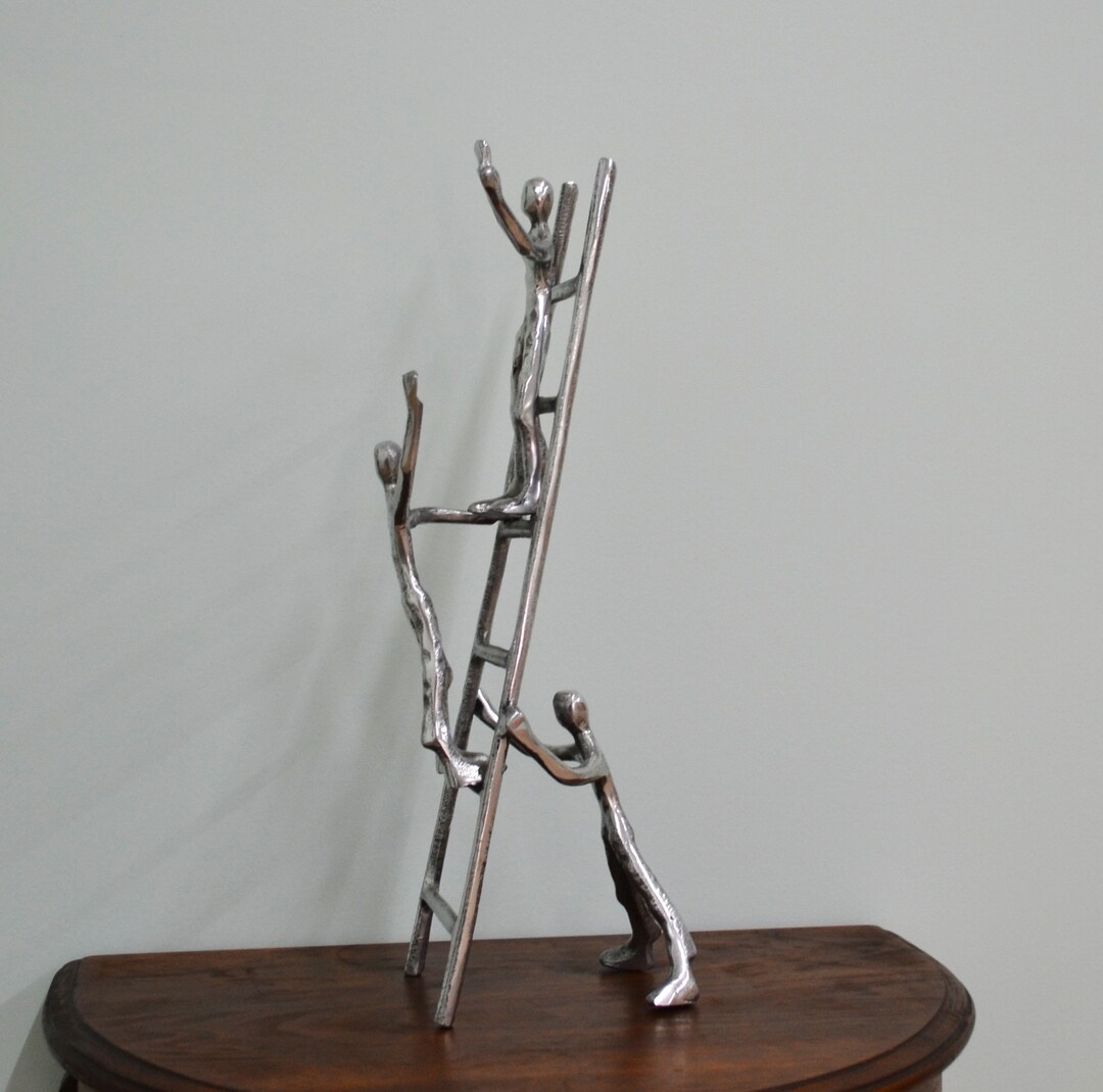 Silvery Metal Minimalist Sculpture Depicting Men on a Ladder. Crafted ...