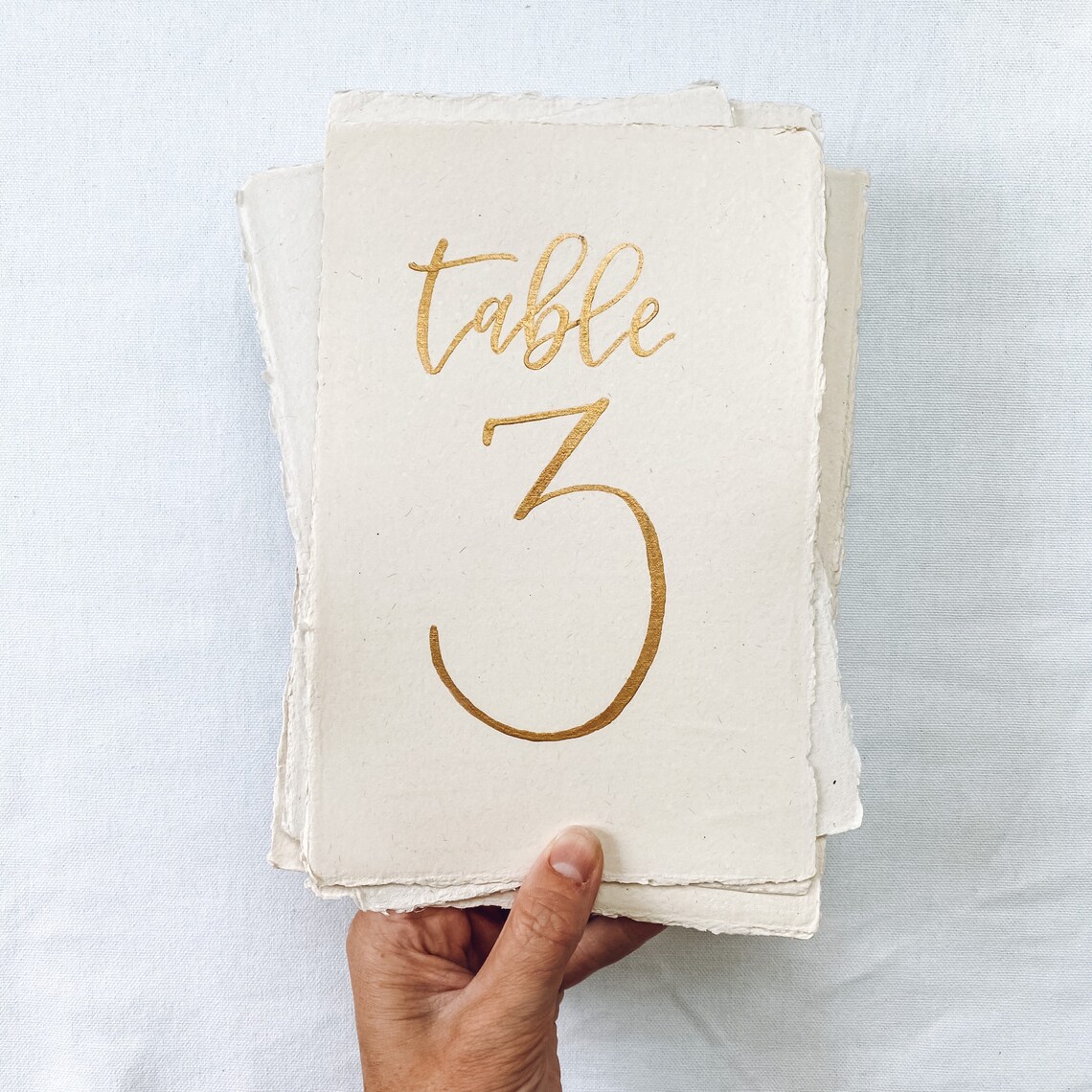 Gold Calligraphy table numbers on hand made paper gold | Etsy