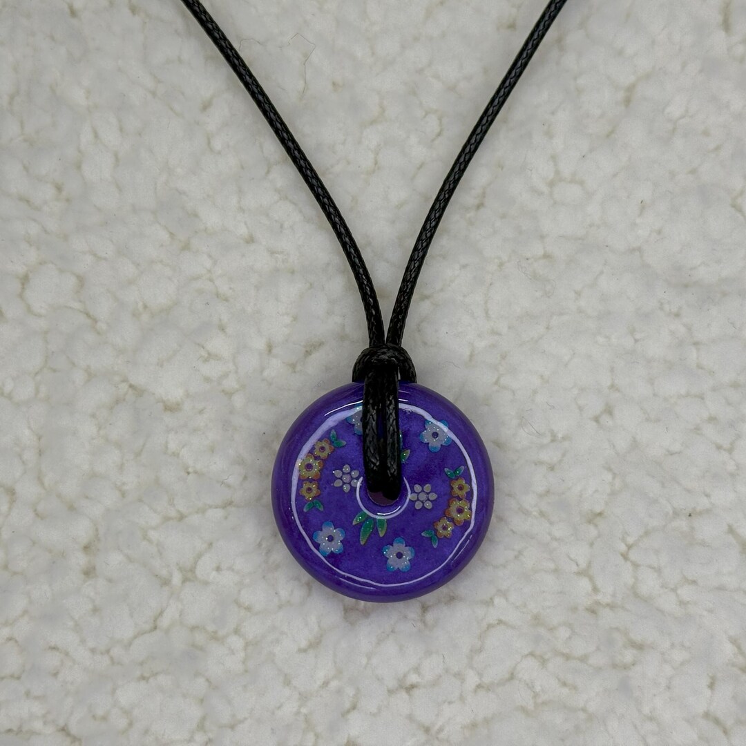 Doughnut-shaped Pendant With Flower Design. Hanging on a 33cm Black ...