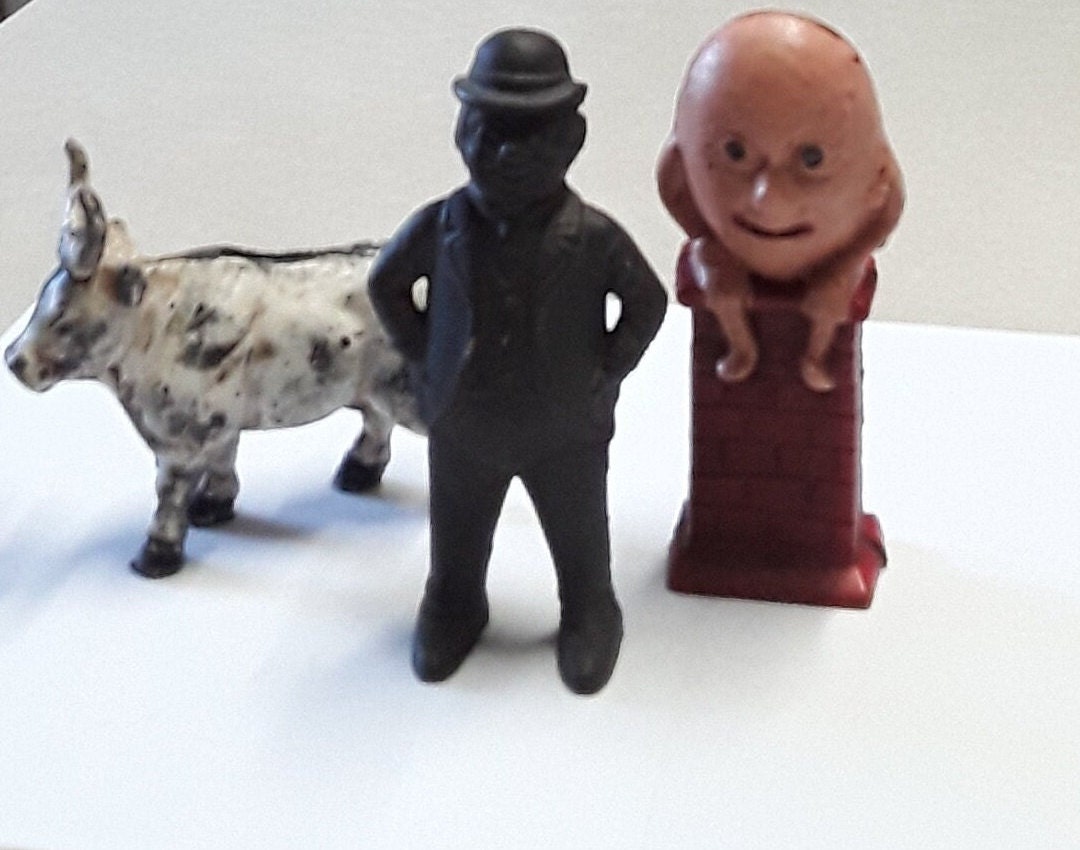 Three Vintage Cast Iron Still Banks, Including Cow, Humpty Dumpty, and ...