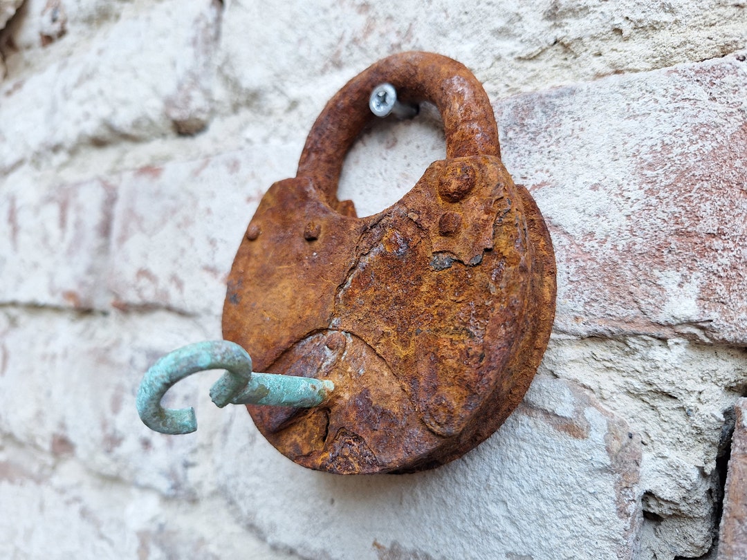 Antique Rusty Padlock With Brass Key Stuck in It Rusty Iron Wall ...