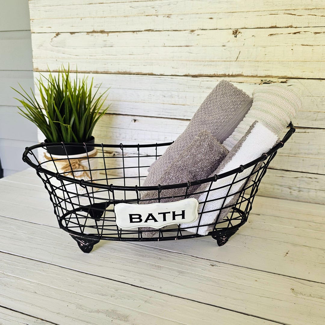 Black Wired Metal Tub Shaped Display With White Metal Tag With the Word ...