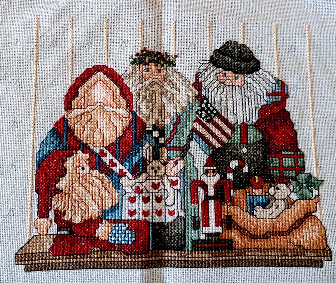 Vintage Handmade Cross Stitch Design With 3 Santa's and Toys on a Grey ...
