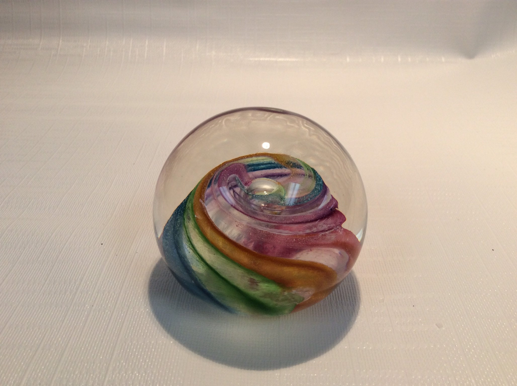signed Marilyn Kimble hand made glass paperweight with multi colored swirls