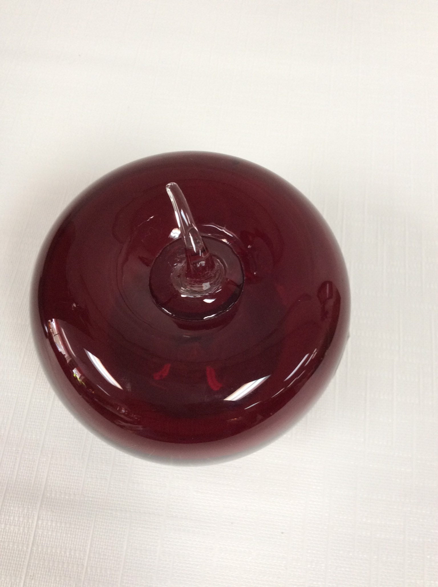 Blenko Glass ruby red apple with crystal stem.