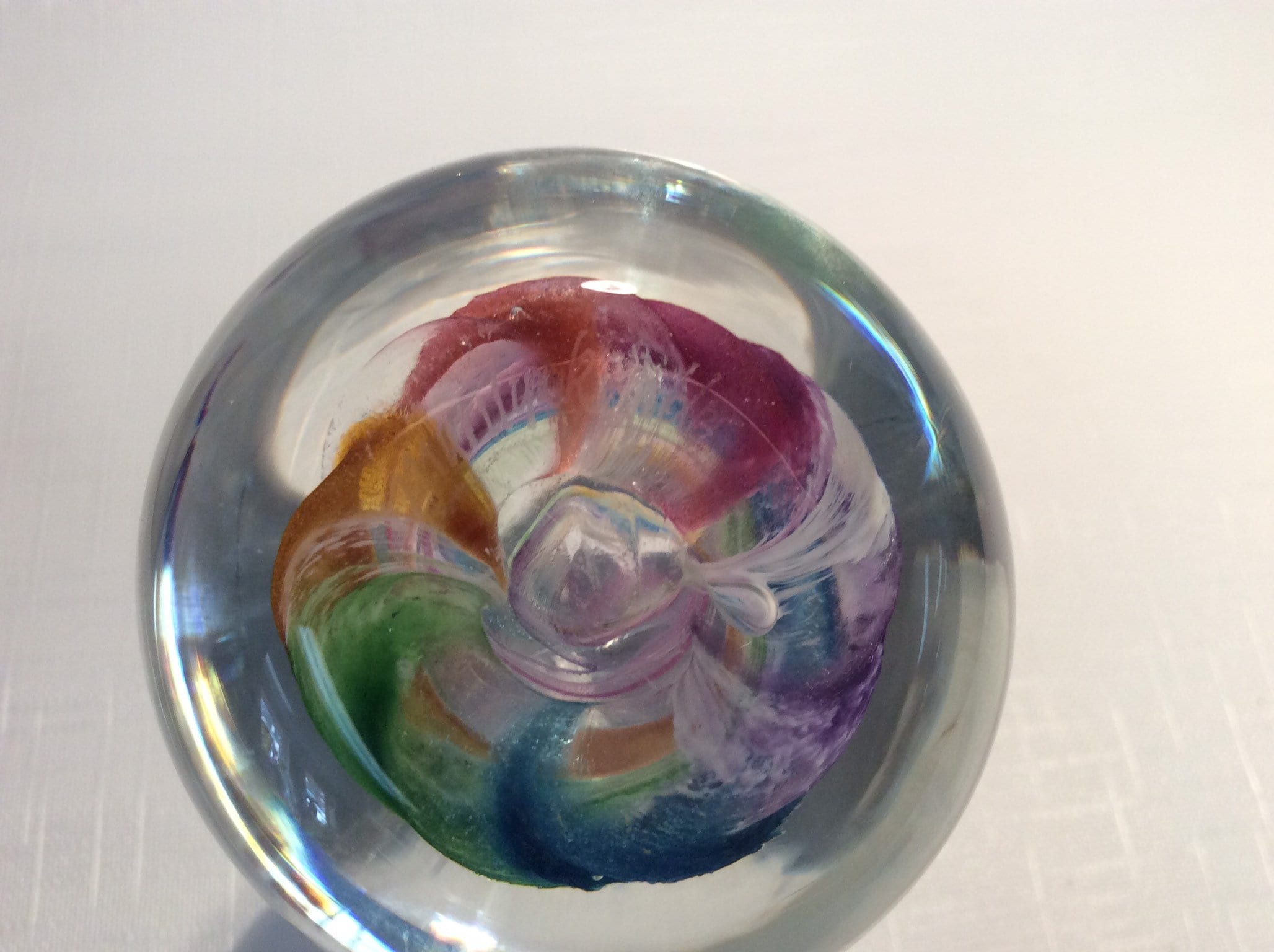 signed Marilyn Kimble hand made glass paperweight with multi colored swirls
