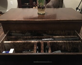 Gun storage coffee table with American flag top.