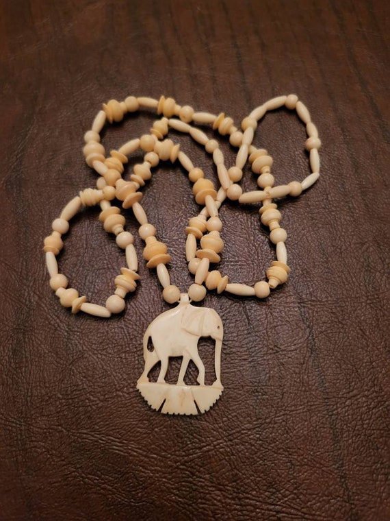 carved elephant pendant and - Gem