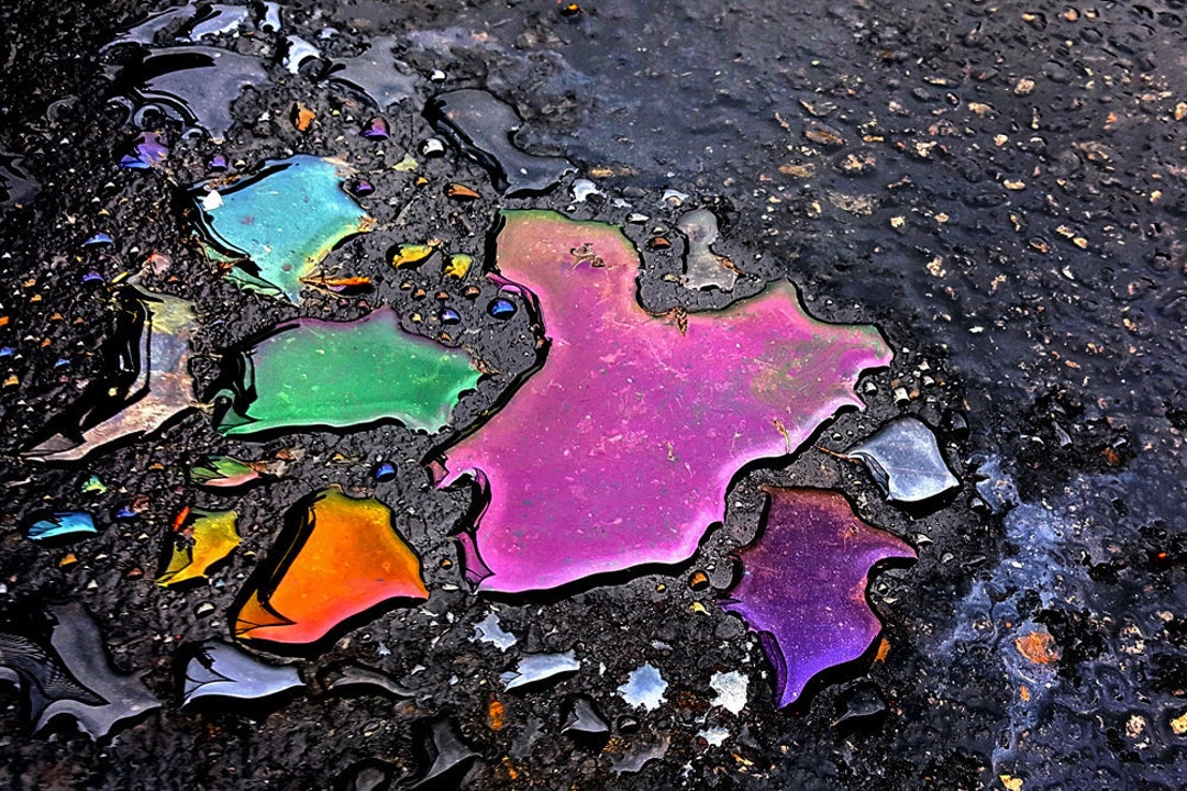 Tiny Rainbow Oil Puddles in a Parking Lot After a Storm Color Photo ...