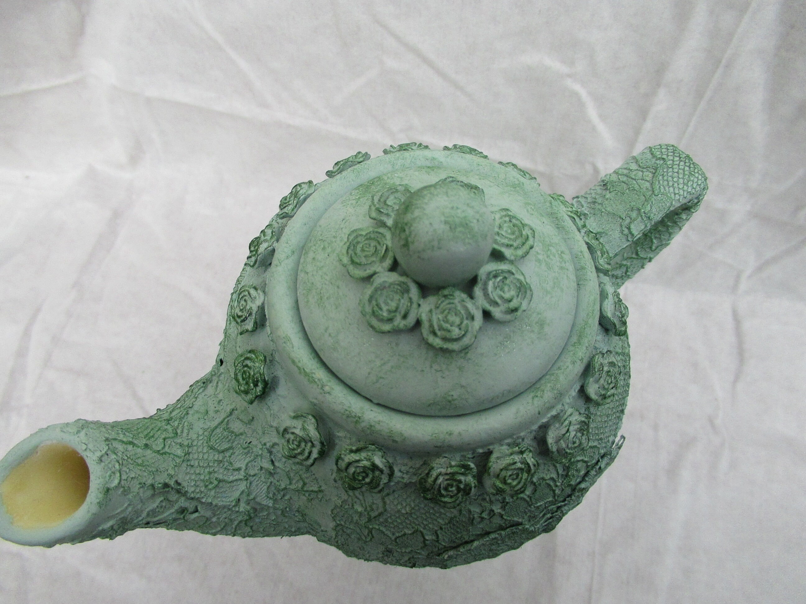 Green Teapot Covered in Lace, on a Stand With Resin Flowers Round the ...