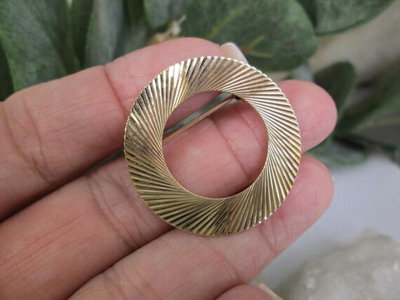 Gold round brooch store