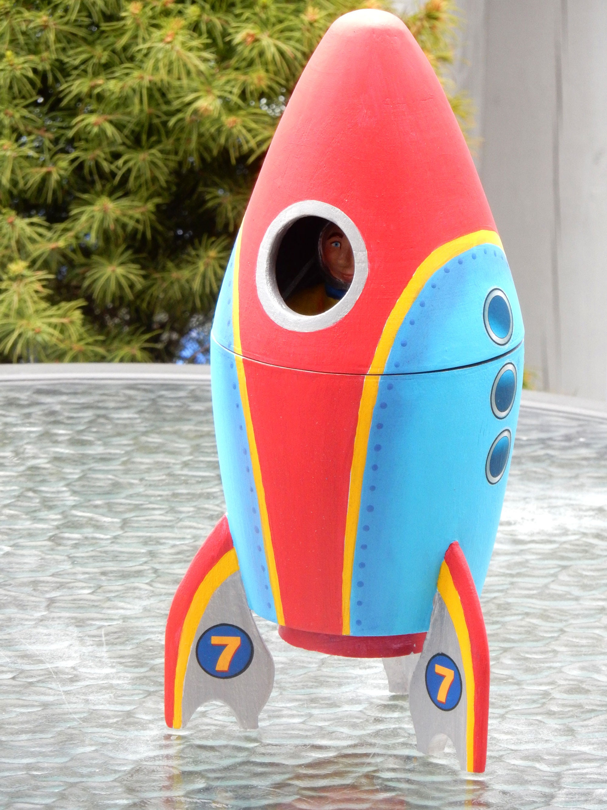 A Wooden Retro Styled Toy of a Rocket With Astronaut Pilot. A Fun Desk ...