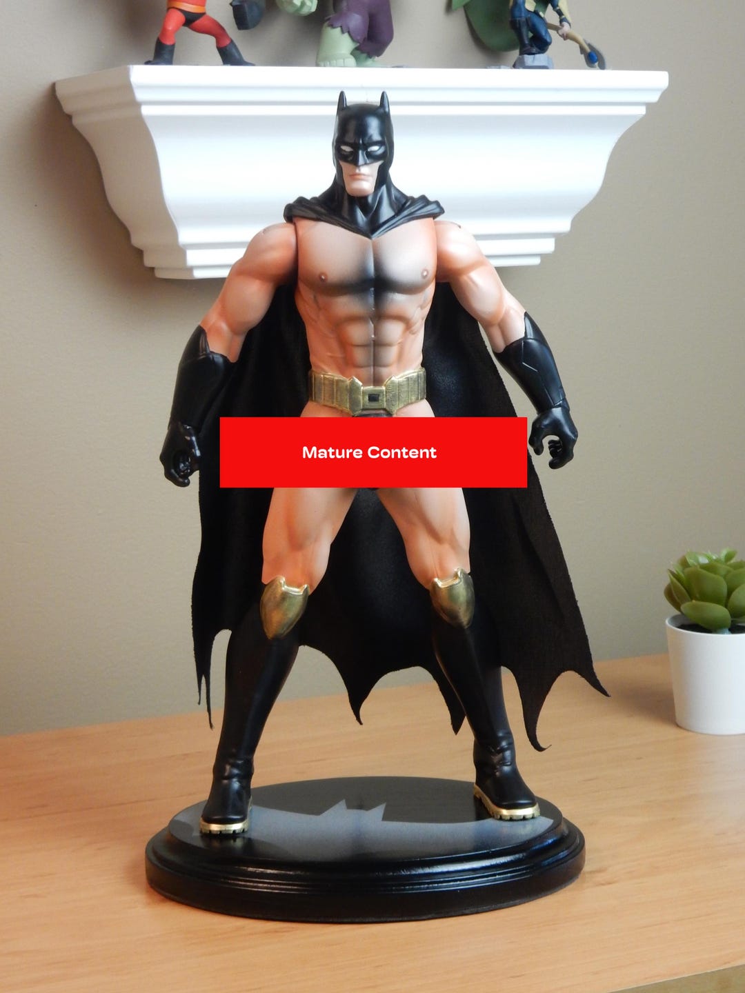 A 12" Sculpture of an Action Hero, in Black Mask & Cape. A Muscle Man ...