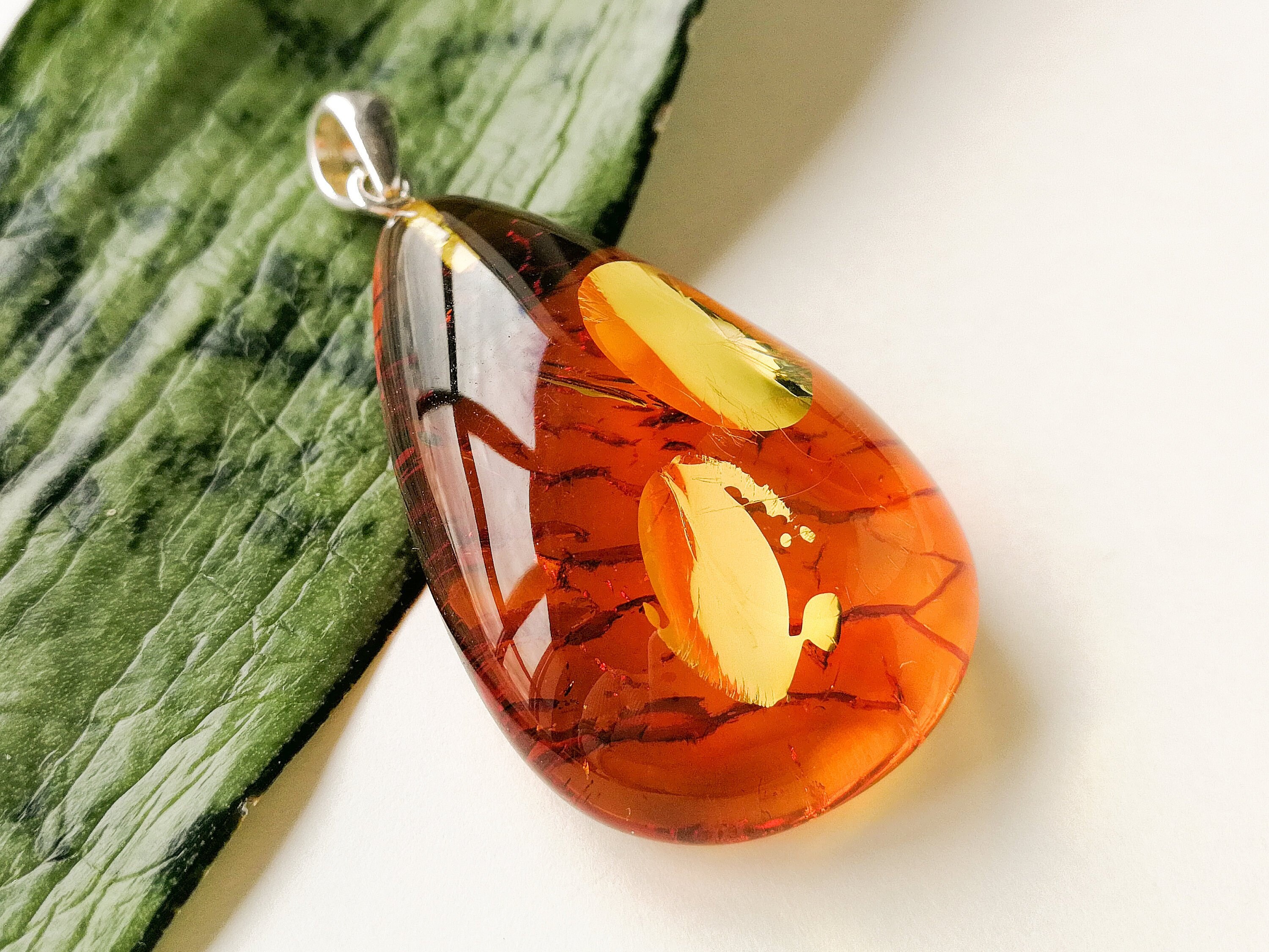 Bright cognac color amber drop pendant with silver medium | Etsy