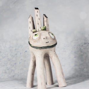 A Funny Monster Carries a City With Skyscrapers. Decoration for Home ...