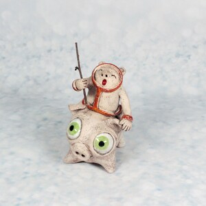 Gnoo-mee Kid Riding on a Pig. Fun Ceramic Figurine of a Playing Gnome ...