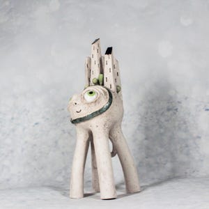 A Funny Monster Carries a City With Skyscrapers. Decoration for Home ...