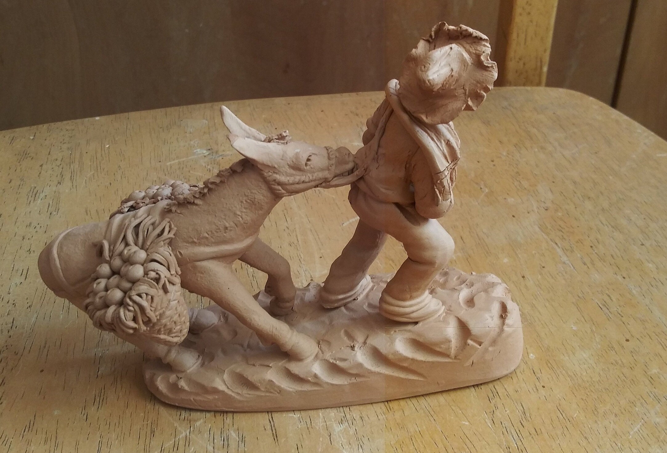 Clay figurine driving a donkey | Etsy