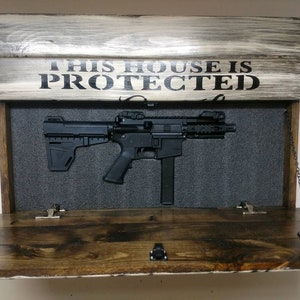 This House is Protected Hidden Gun Storage Sign - Etsy