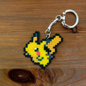 Pichu, Pikachu, Raichu and Alolan Raichu Pokemon Keychains, Pins ...