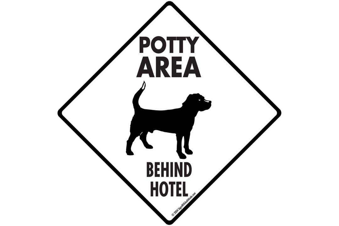 Potty Area Sign - Dog Standing Potty Area Behind Hotel Exterior ...