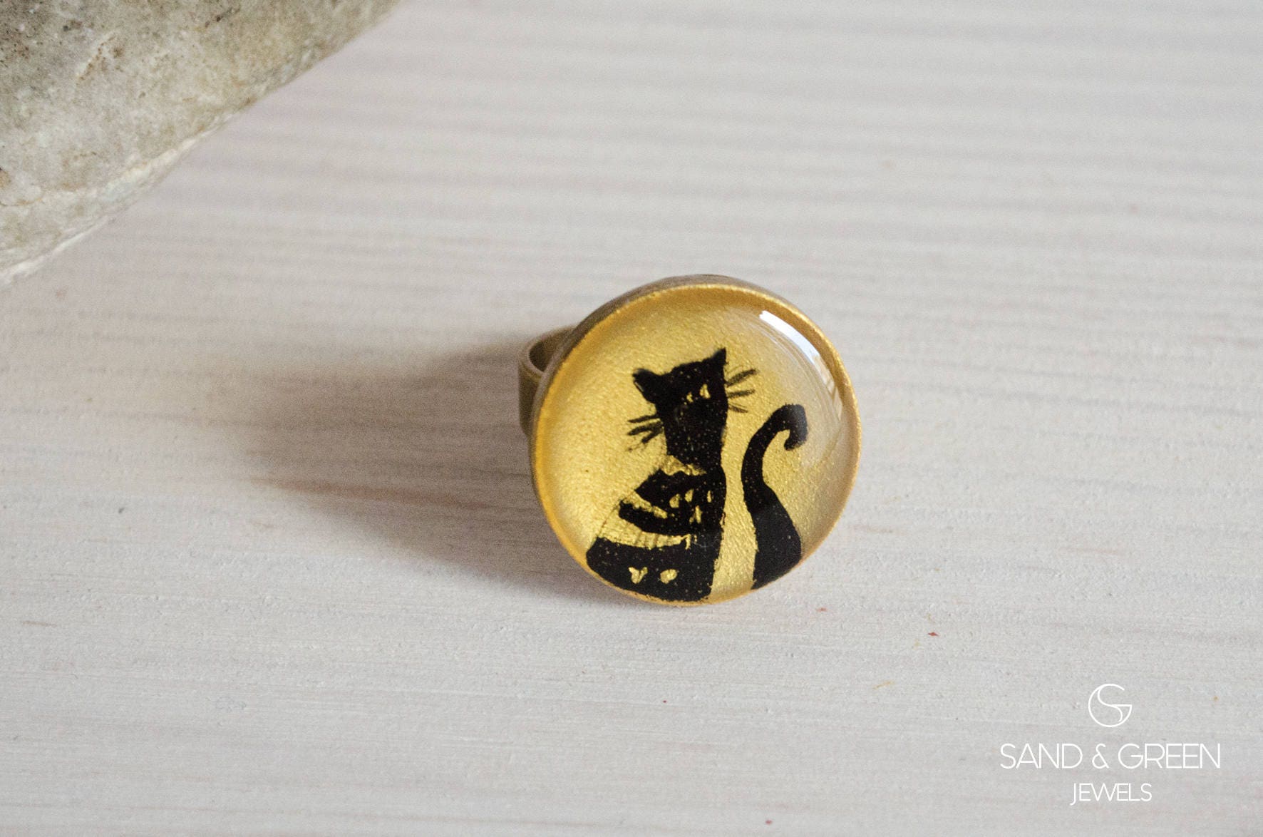 Bronze Round Ring on One Black Cat in Gold Background Theme, Hand ...