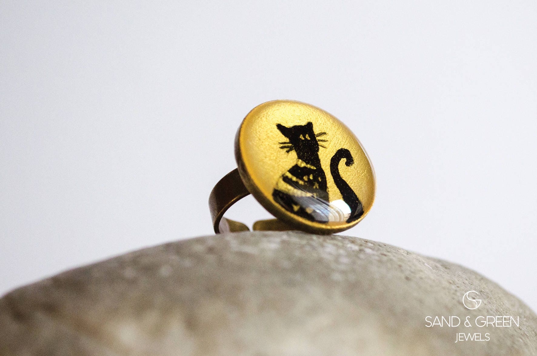 Bronze Round Ring on One Black Cat in Gold Background Theme, Hand ...