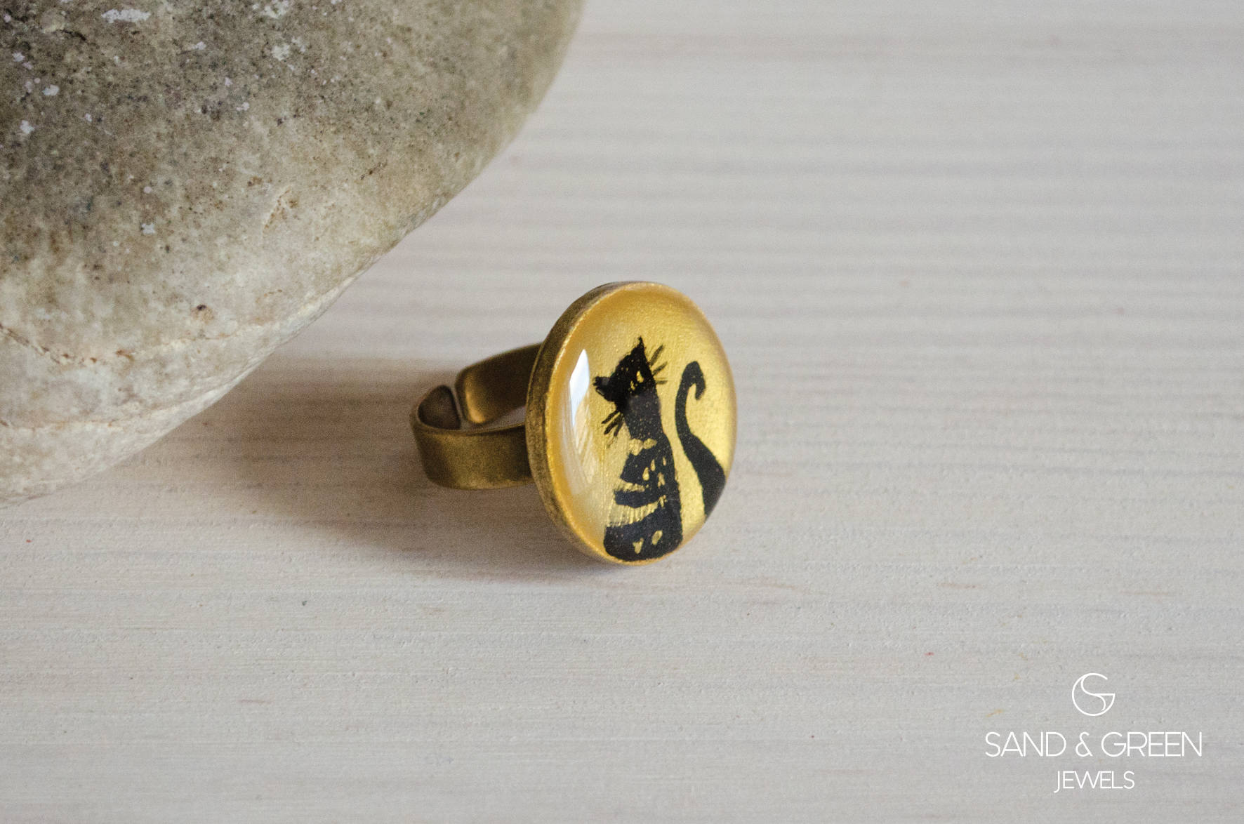 Bronze Round Ring on One Black Cat in Gold Background Theme, Hand ...
