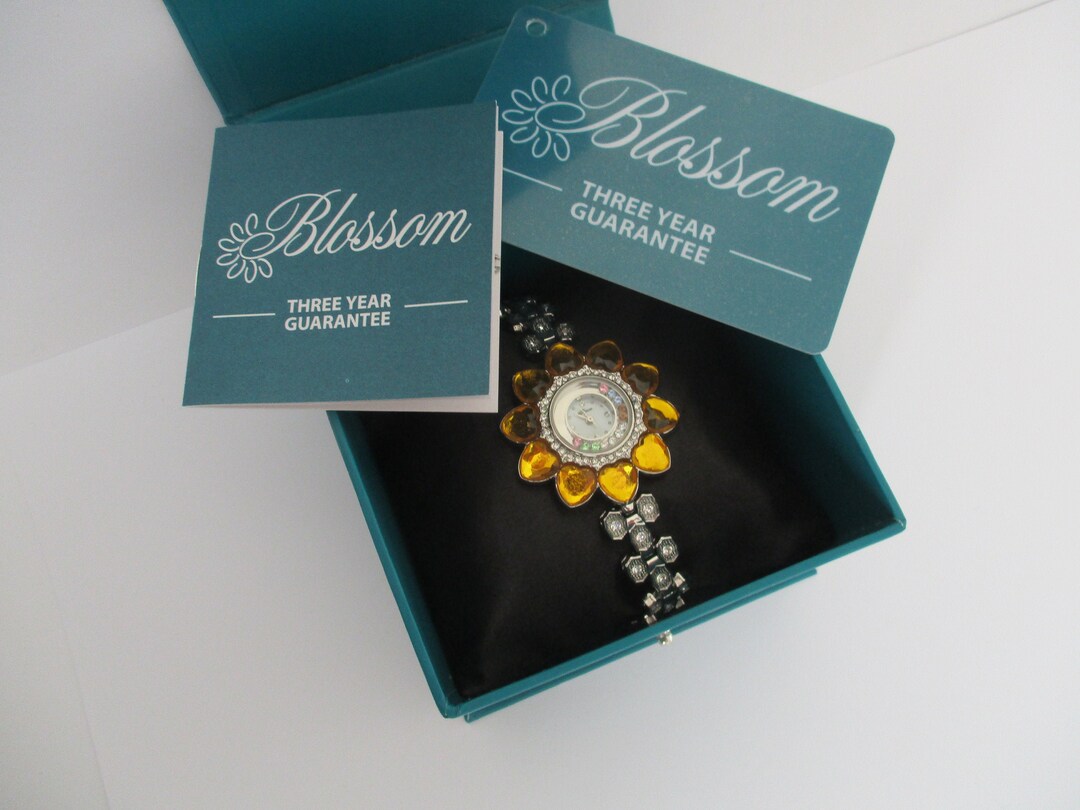 A Ladies Flower Blossom Quartz Watch With Coloured Rotating Stones in ...