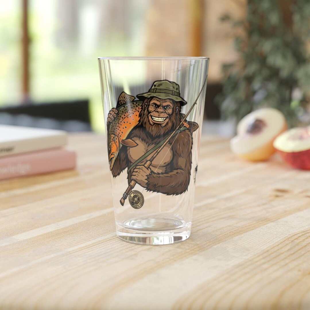 Bigfoot Carrying Trophy Brown Trout Fishing Pint Glass, Sasquatch ...