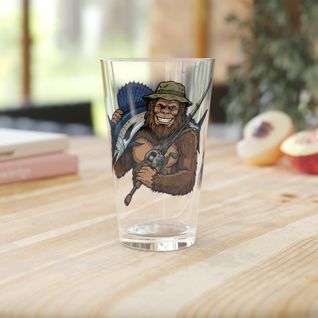 Bigfoot Carrying Trophy Sailfish Fishing Pint Glass, Sasquatch ...