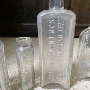 4 Embossed Bottles. Distressed Clear Bottles. 3 Cooking, 1 Medicine Vintage Bottle Collection ...