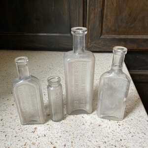 4 Embossed Bottles. Distressed Clear Bottles. 3 Cooking, 1 Medicine Vintage Bottle Collection ...
