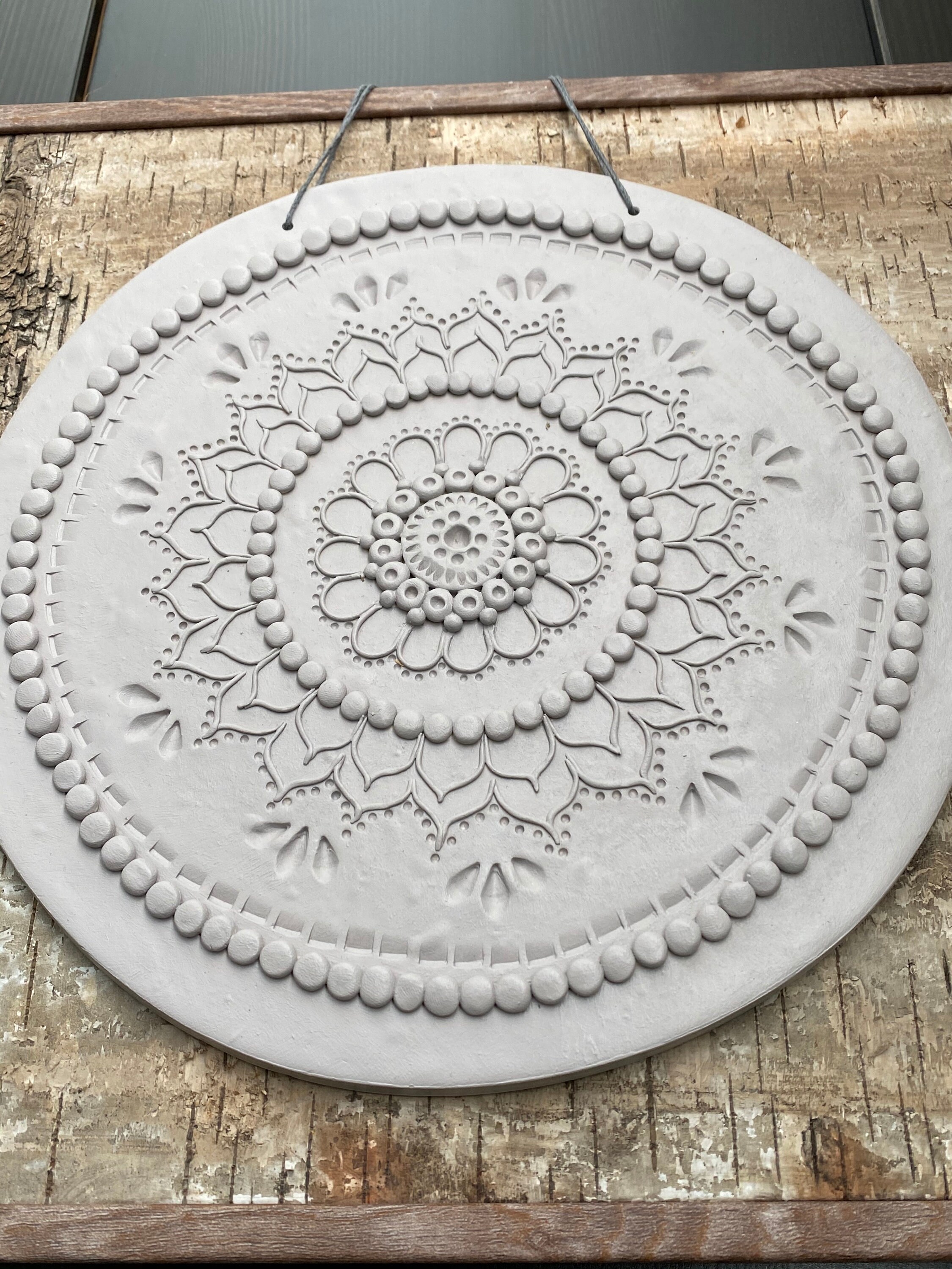 Gray hand sculpted clay mandala wall art on real bark backing | Etsy