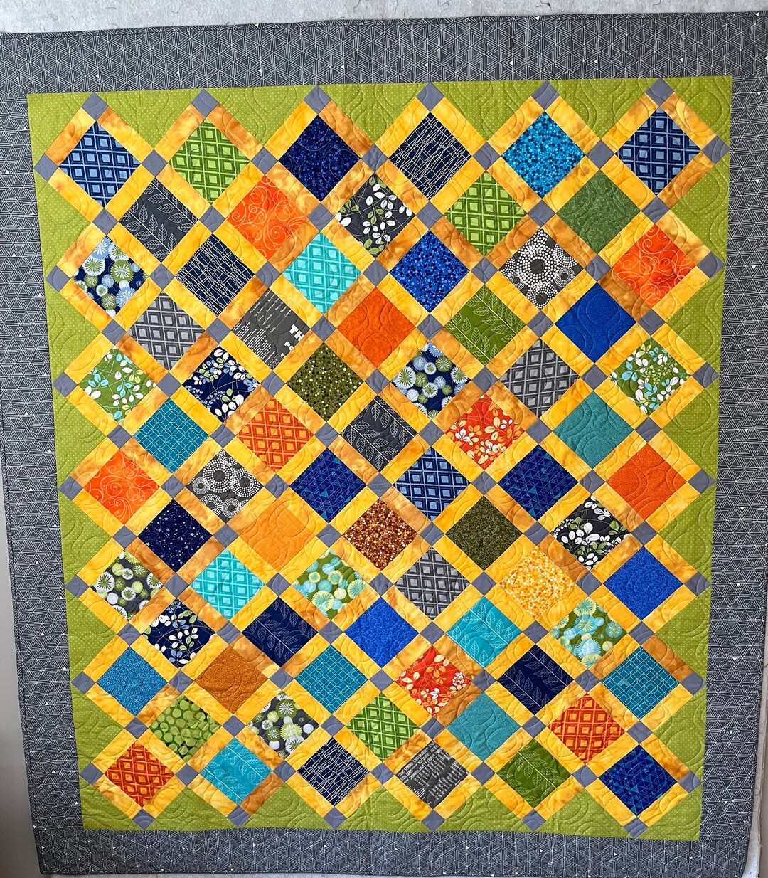 Bright Quilt Made With Charm Squares Set on the Diagonal With Yellow ...