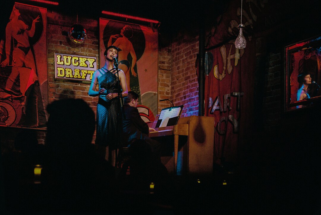 1920s Flapper Era Singer at a Secret Speakeasy Draped in Red Light ...