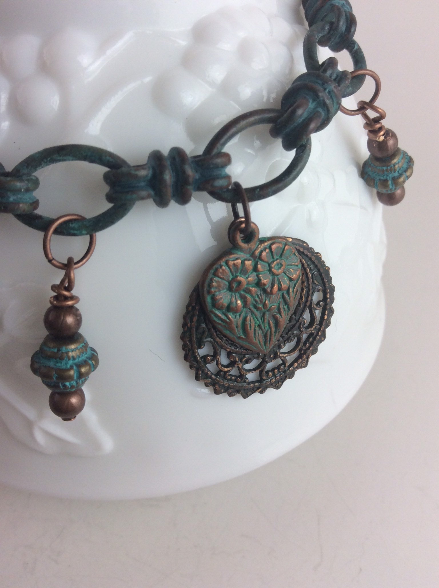 Copper charm bracelet with beautiful patina.