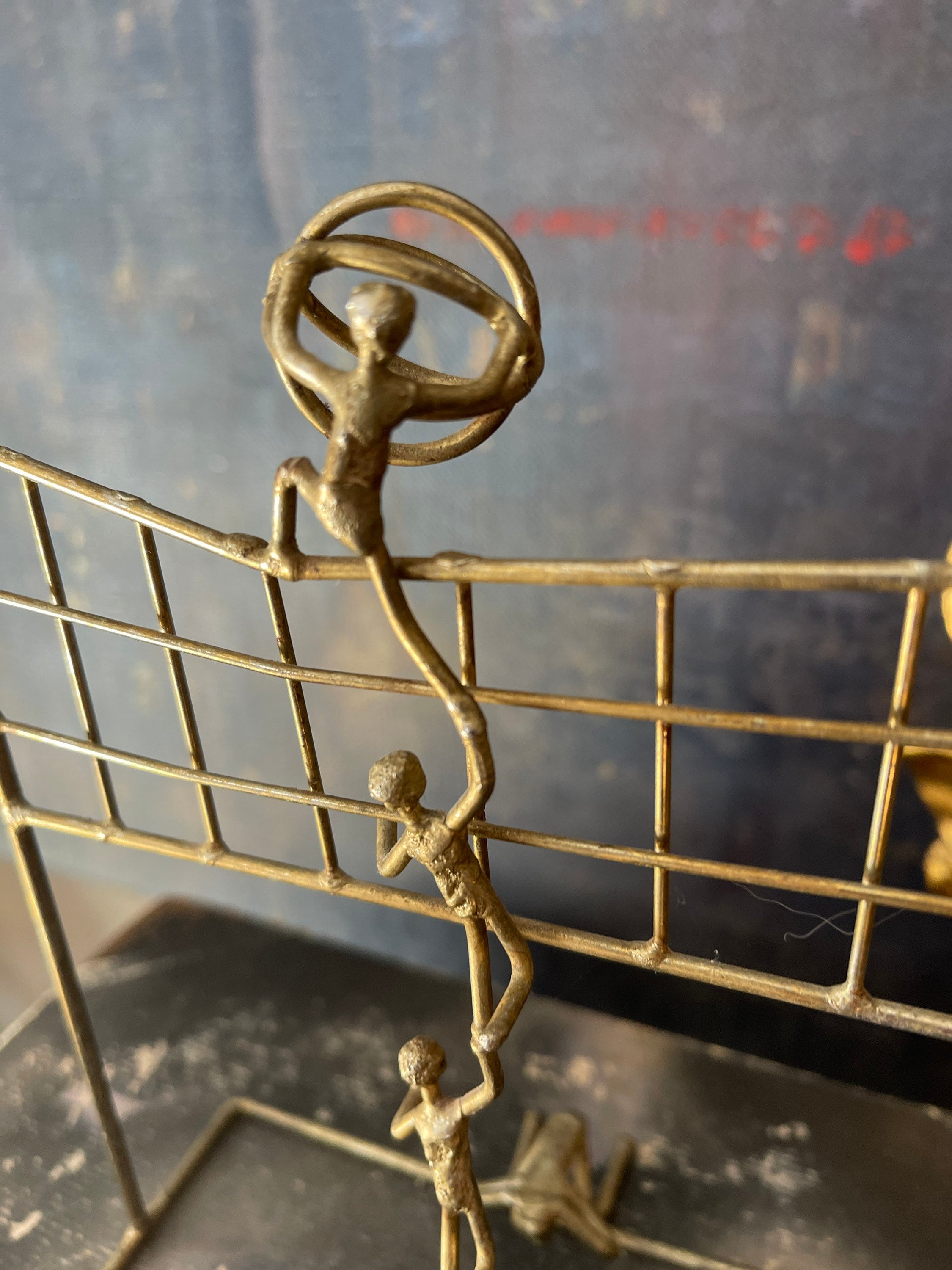 Gold Metal Sculpture of Volleyball Teamwork