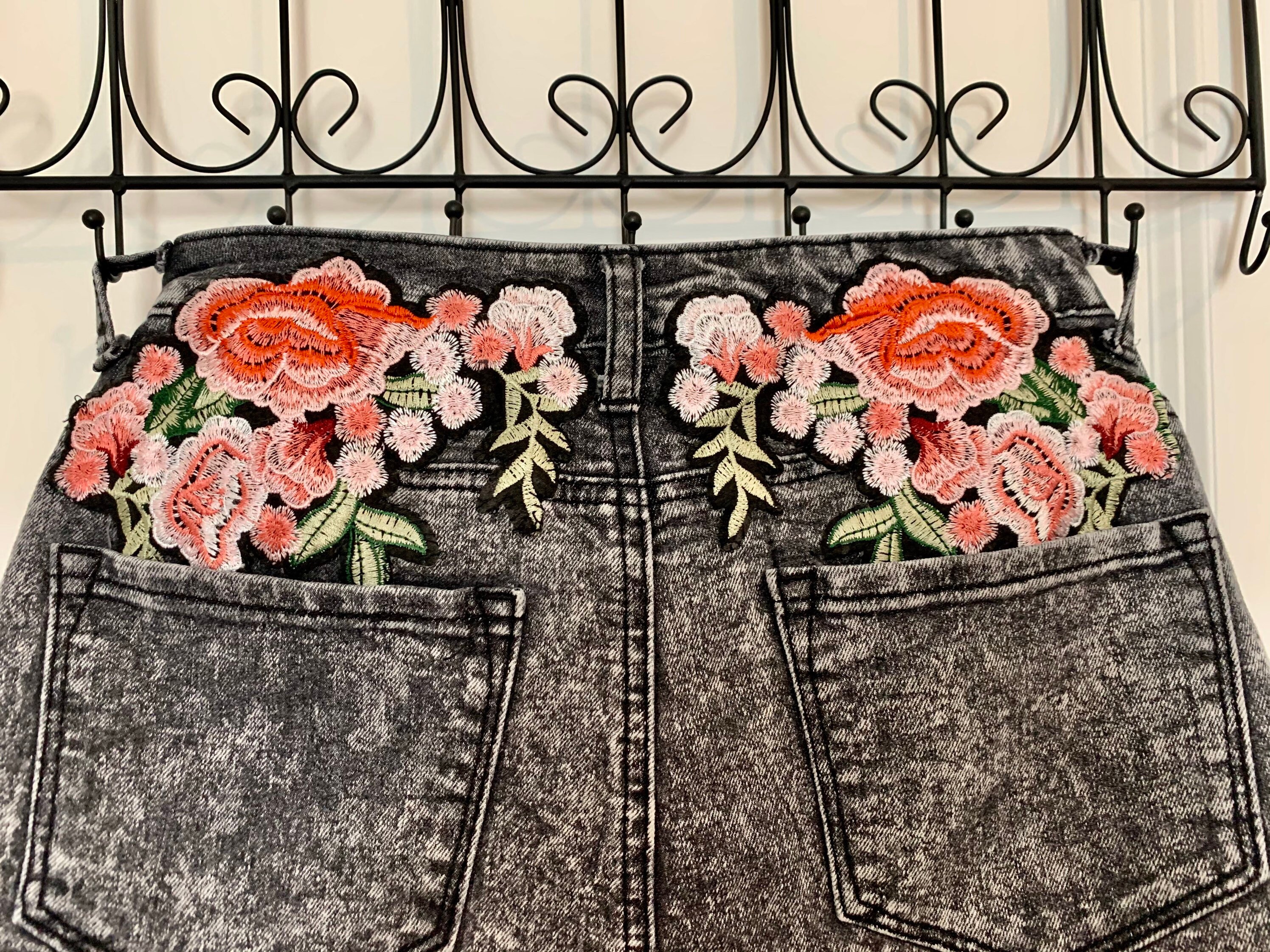 Beautiful floral embroidery on distressed, fringed black denim shorts ...