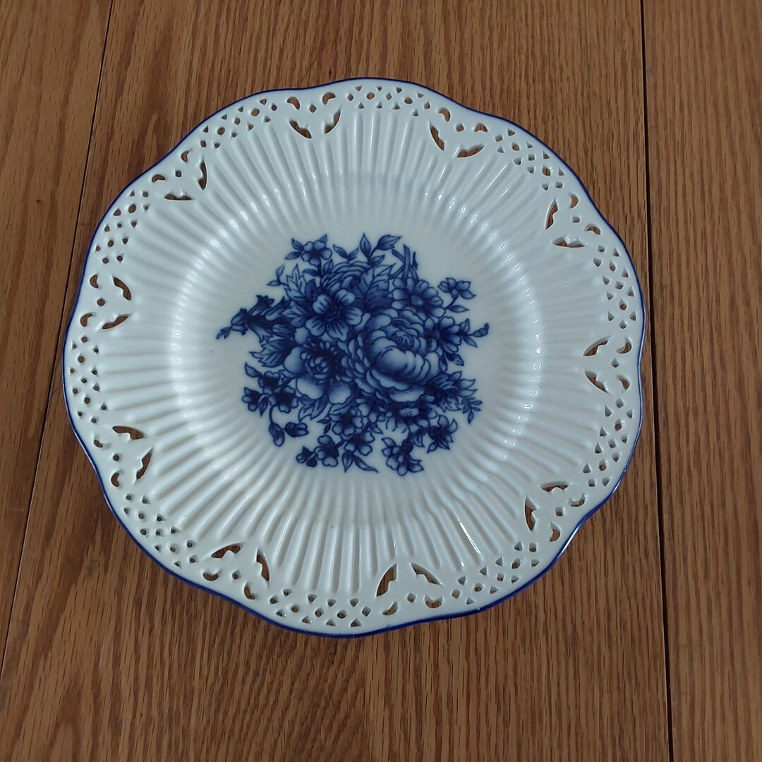 A White Ribbed 10" Plate With Blue Floral Designed and a Scalloped ...
